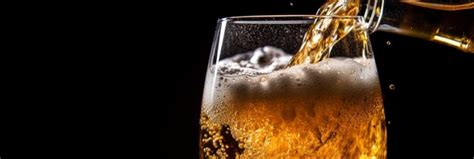 Premium Ai Image Beer Is Elegantly Poured Into A Large Glass Against