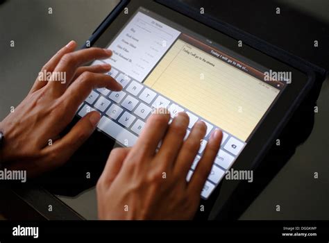 Woman Writing A Note In Her IPad Stock Photo Alamy