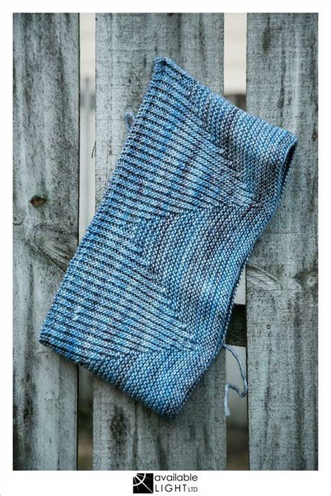 A Blue Knitted Cloth Hanging On A Wooden Fence A Blue Knitted Cloth Hanging On A Wooden Fence
