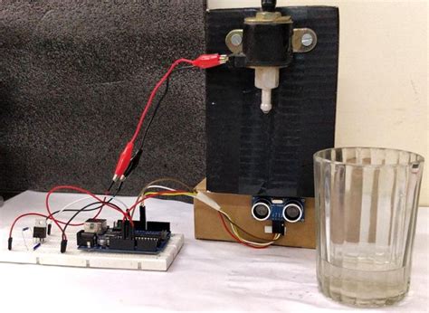 An Electronic Device Is Sitting On A Table Next To A Glass And Some