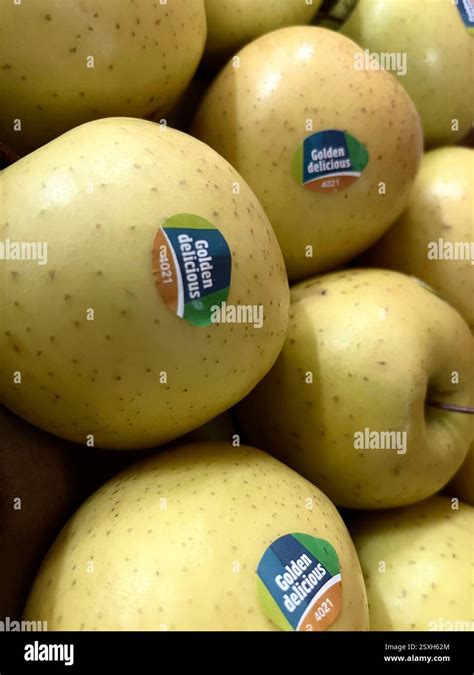 Apples Labeled With Golden Delicious Stickers Featuring The Plu Code 4021 Displayed In A Retail