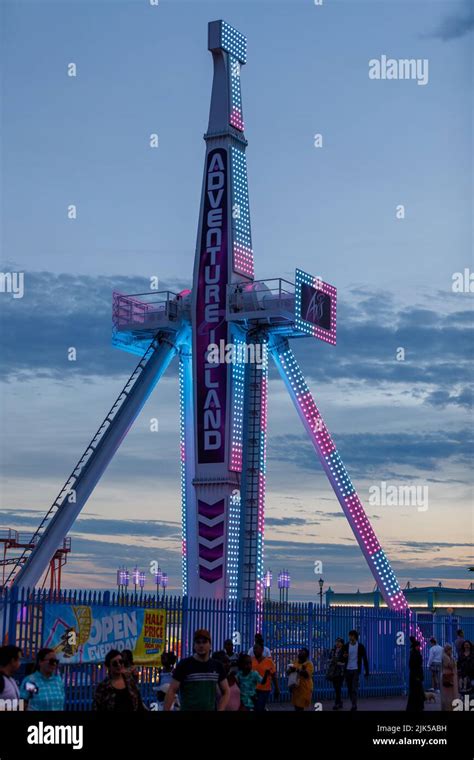 A Pendulum Ride Roller Coaster Lit Up With Multi Color Light Bulbs At