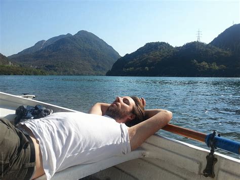 Man On A Boat In A Alpine Lake By Stocksy Contributor Vero Stocksy