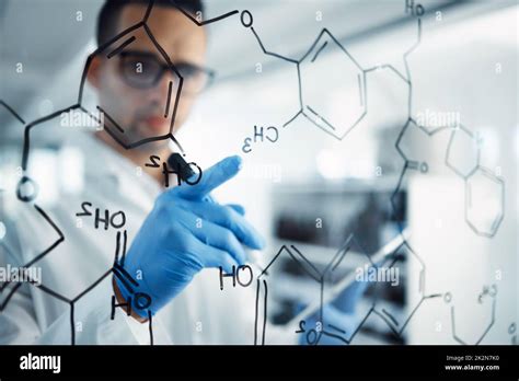 The Science Man With A Plan Shot Of A Young Scientist Solving Equations On A Glass Screen In A