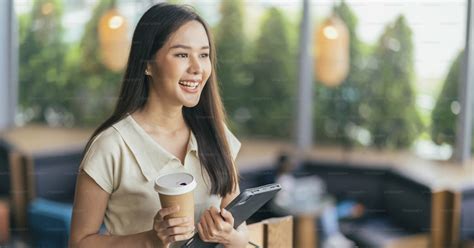 캐주얼 휴식 아시아 여성 프로그램 코딩 디지털 Momad 라이프 스타일 손 잡고 태블릿과 커피 컵 미소 쾌활한 평화로운 느낌 어디서나 일하다 카페 레스토랑에 서서 다운