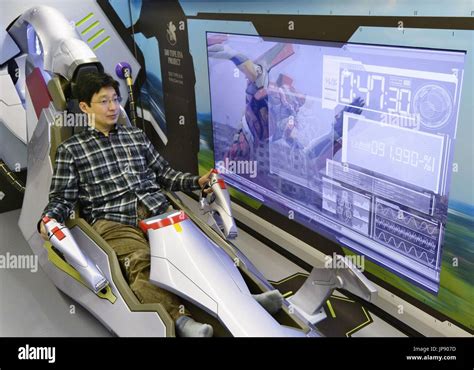 A Man Sits In A Life Sized Version Of A Mecha Cockpit From Japanese