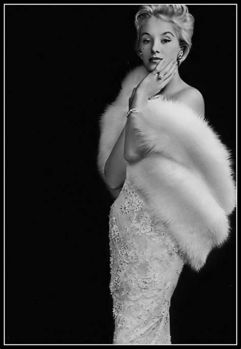 Barbara Cailleux In White Lace And Embroidered Evening Gown By Carven Worn With White Fox Stole