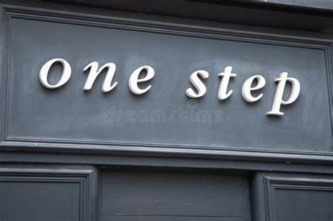 One Step Brand Sign And Text Logo Front Facade Store Fashion Women Boutique Editorial Stock