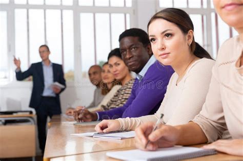 Smiling Young Brunette On Ecture During Adult Education Class Stock