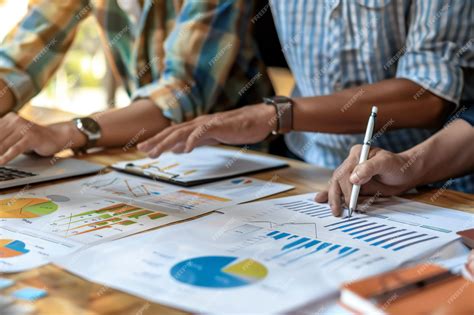 Team Collaboration In Business Meeting Analyzing Charts And Data For Strategic Planning