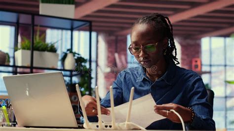 Black Woman At Home Examines The Modem And Troubleshooting Guide Book Stock Video Video Of
