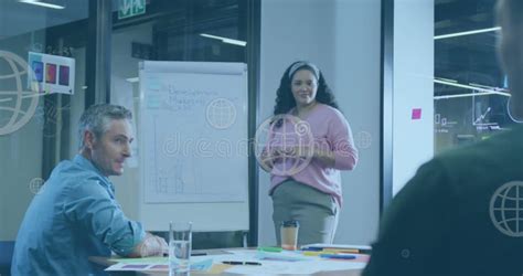 Image Of Web Globe Icons Floating Against Biracial Woman Giving A Presentation At Office Stock