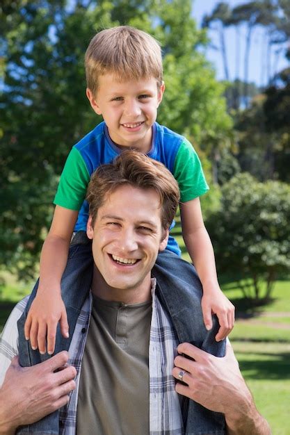 Premium Photo Father And Son Having Fun In The Park