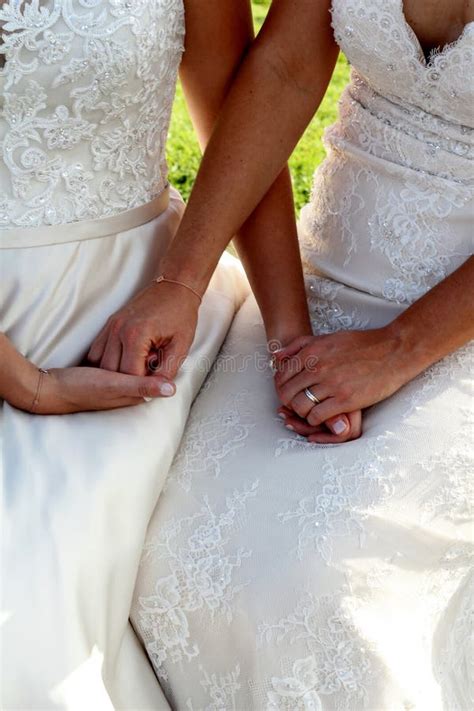Two Brides Same Sex Wedding Couple Looking At Dress Mannequin Stock
