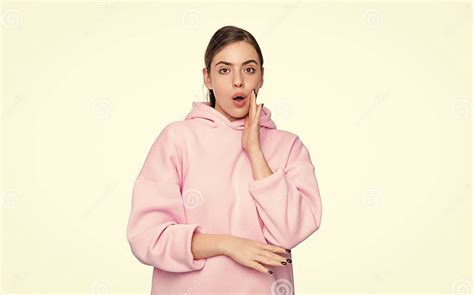 Surprised Young Girl In Pink Hoodie Isolated On White Background Stock