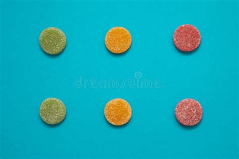 Colored Round Gummy Candies Isolated On Blue Background With Copy Space