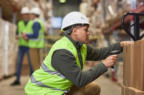 Premium Photo Female Worker Scanning Codes On Boxes In Storage Warehouse