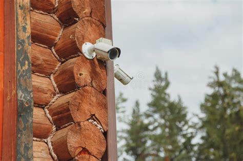 Security Camera Installed On The Corner Of Log Wooden House Stock Image
