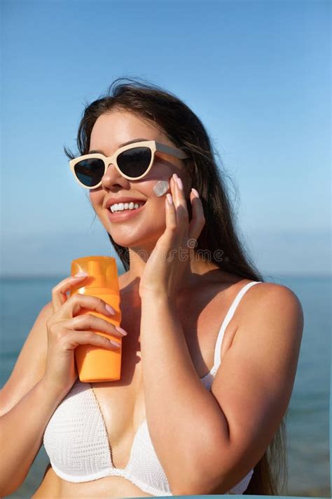 Beautiful Woman Applying Cream Sunscreen On Tanned Face Sunscreen