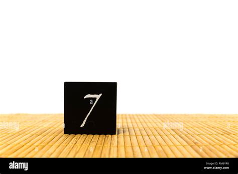 Black Number 7 Block On Bamboo Underground And With Isolated White