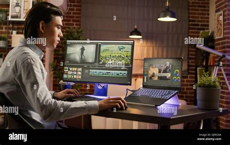 Graphic Designer Working On Editing Footage Software To Edit Video Montage With Color Gradient