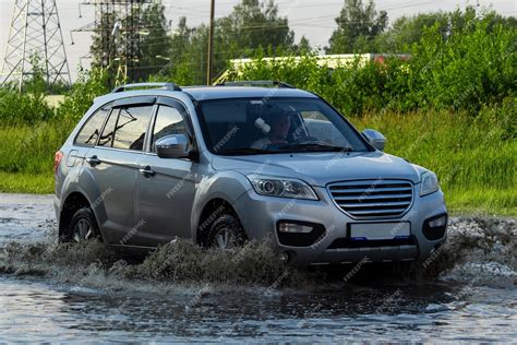 Premium Photo Suv Is Driving Through A Deep Puddle The Consequences Of A Downpour