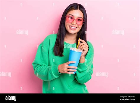 Portrait Of Positive Cute Thai Girl Toothy Smile Hands Hold Plastic Drink Cup Isolated On Pink