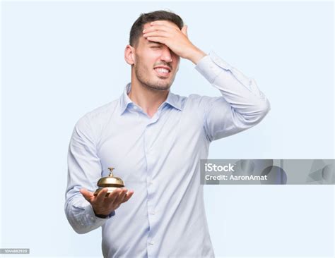 잘생긴 젊은 남자 머리에 손으로 압박 하는 호텔 링 벨 들고 충격 수치심과 깜짝 얼굴로 분노와 좌절 두려워 하 고 실수에 대 한 화가 감정에 대한 스톡 사진 및 기타 이미지