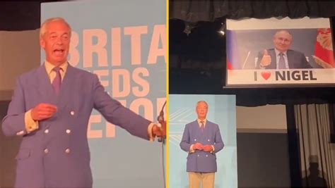 Activists Lower Vladimir Putin Banner Behind Nigel Farage As He Gives A