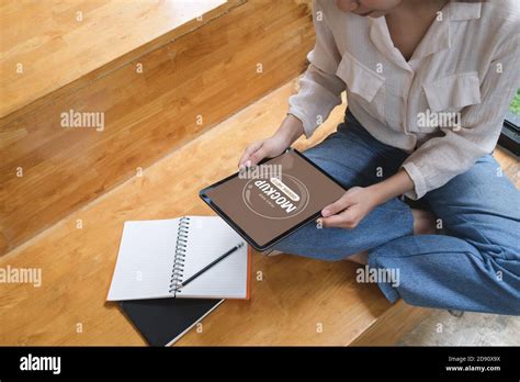 Female Freelancer Using Mock Up Tablet While Sitting On Floor At Home
