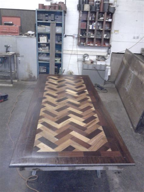 A Table Made Out Of Wood And Metal In A Room With Other Items On Shelves