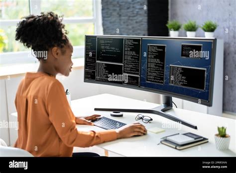 Computer Programmer Writing Program Code On Computer In Office Stock