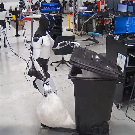 Teslas Optimus Humanoid Robot Learns New Skills Dumping Trash