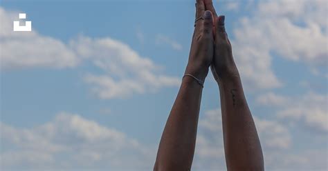 낮에 푸른 하늘과 흰 구름 아래에서 오른손을 들고 있는 사람 사진 Unsplash의 무료 파랑 이미지