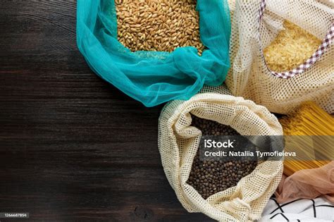 부엌의 검은 나무 테이블에 재사용 가능한 면 봉투에 파스타 쌀 메밀 그로트 제로 폐기물 개념 맨 위 보기입니다 친환경 또는 플라스틱 없는 라이프스타일 컨셉 0에 대한 스톡