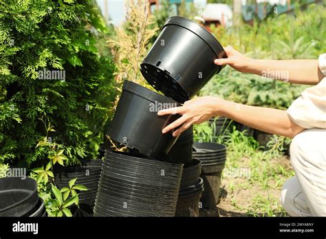 Woman With Black Pots For Tree Planting Outdoors Closeup Stock Photo Alamy