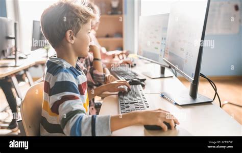 Elementary School Classroom Smart Boy Uses Personal Computer Learning How To Use Internet