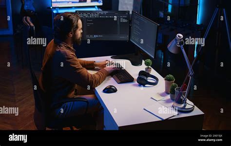 computer scientist developing code on pc while in apartment office