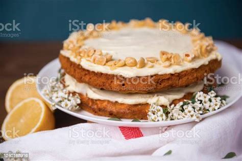 헤이즐 너트와 당근 케이크 목조 테이블에 초원의 흰색 꽃으로 장식달콤한 슬라이스 레몬 당근 비스킷과 사워 크림으로 요리 파이 개암나무에 대한 스톡 사진 및 기타 이미지