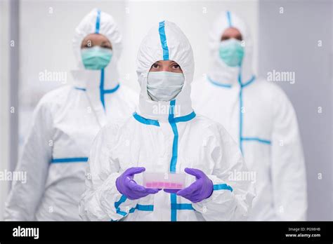 Lab Technician Carrying A Cell Based Testing Kit In A Laboratory That