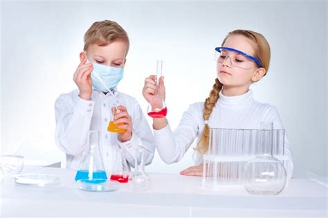 Free Photo Serious Schoolgirl Looking Flask With Chemical Liquid