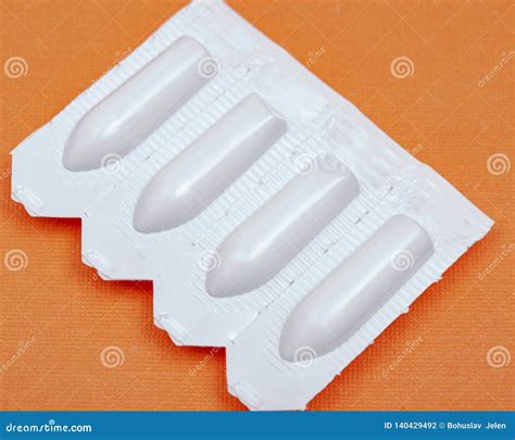 Medication In Disposable Plastic Suppository Moulds On Orange Rectal