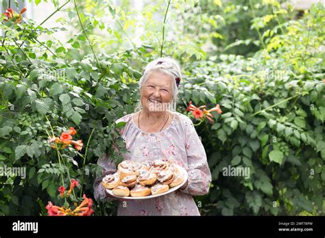 Platter Of Buns In The Hands Of A Happy Gray Haired Grandmotherhappy