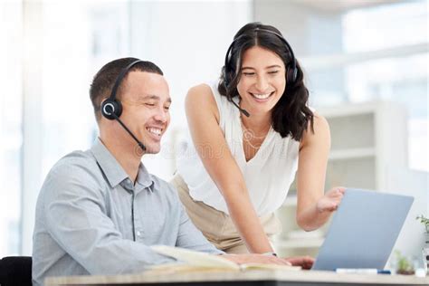 Its So Simple Ill Show You Two Call Centre Agents Working Together On A Laptop In An Office