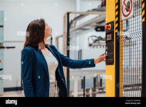 Businesswoman Touching Push Button On Control Panel In Industry Stock Photo Alamy