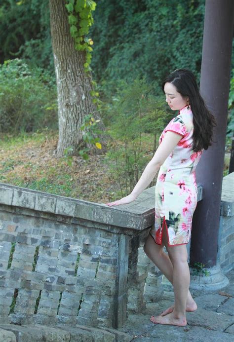 A Chinese Woman Wears Traditional Dress In The Water Park Of Shanghai