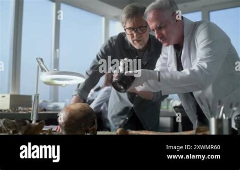 Senior Paleoanthropologist Takes Photo Of Fossil Remains Of Prehistoric Human Skull With