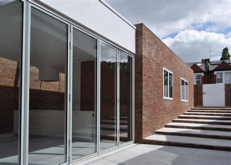 Jack Woolley S Spiral House Hides Itself Behind A Brick Wall