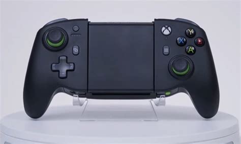 A Close Up Of A Nintendo Wii Game Controller On A White Stand With Two