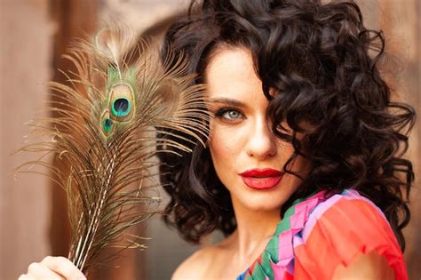Premium Photo A Woman With A Peacock Feather On Her Head